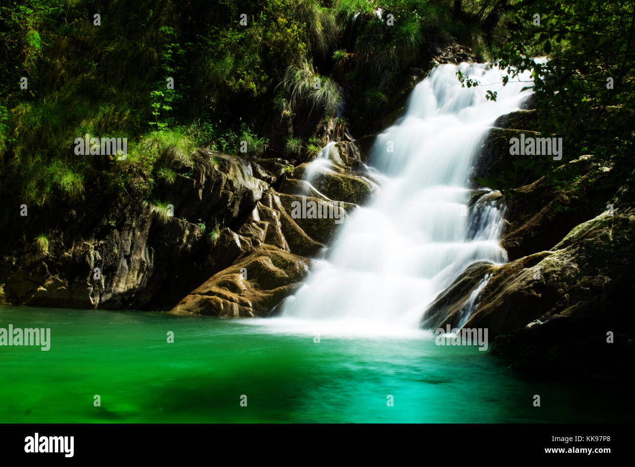A scene with a beauty emerald waterfall Stock Photo - Alamy