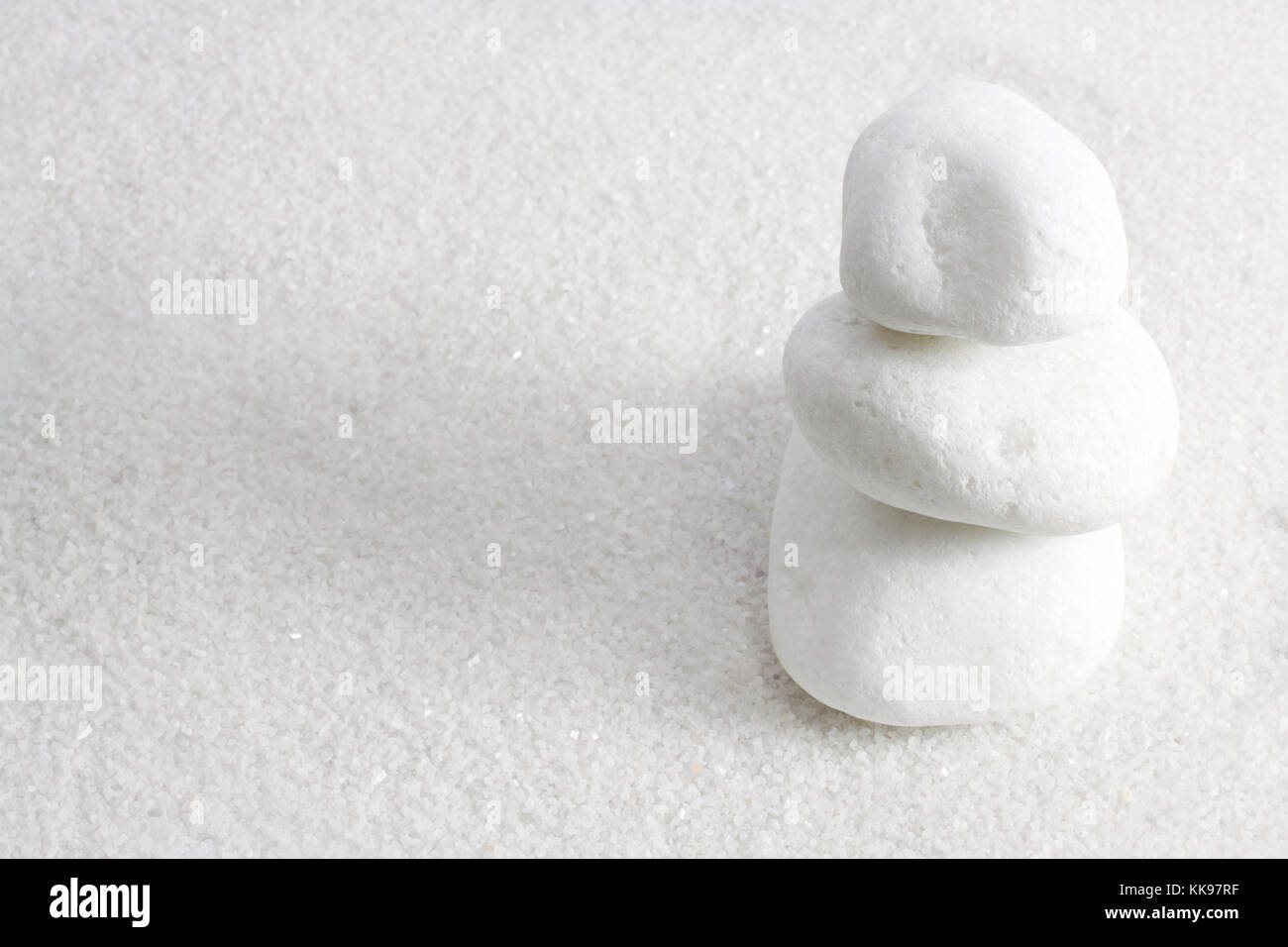 White zen stones with white sand all over Stock Photo - Alamy