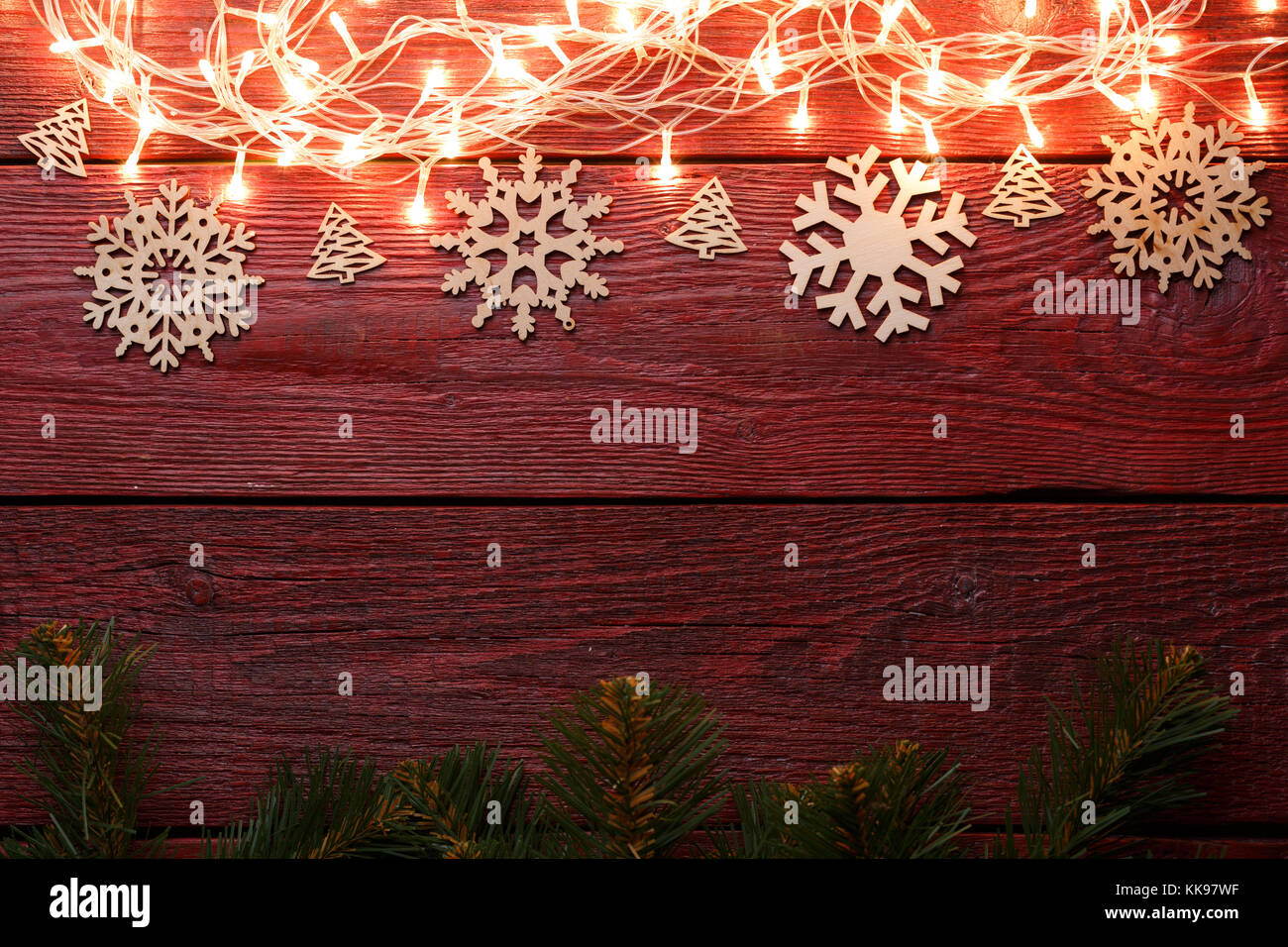 Picture of New Year's wooden red table with burning garland on top ...