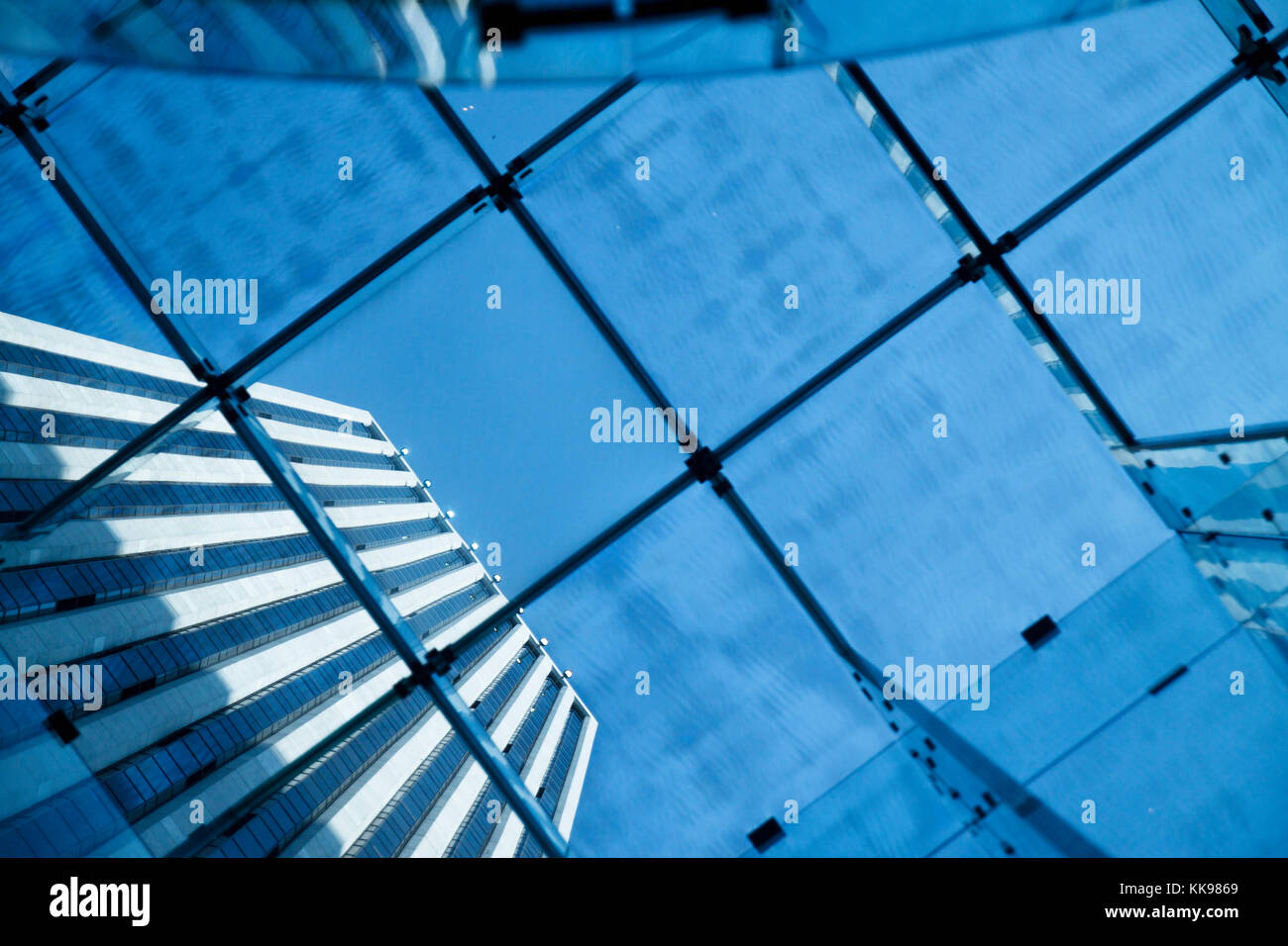 Modern glass building seen through glass ceiling Stock Photo - Alamy