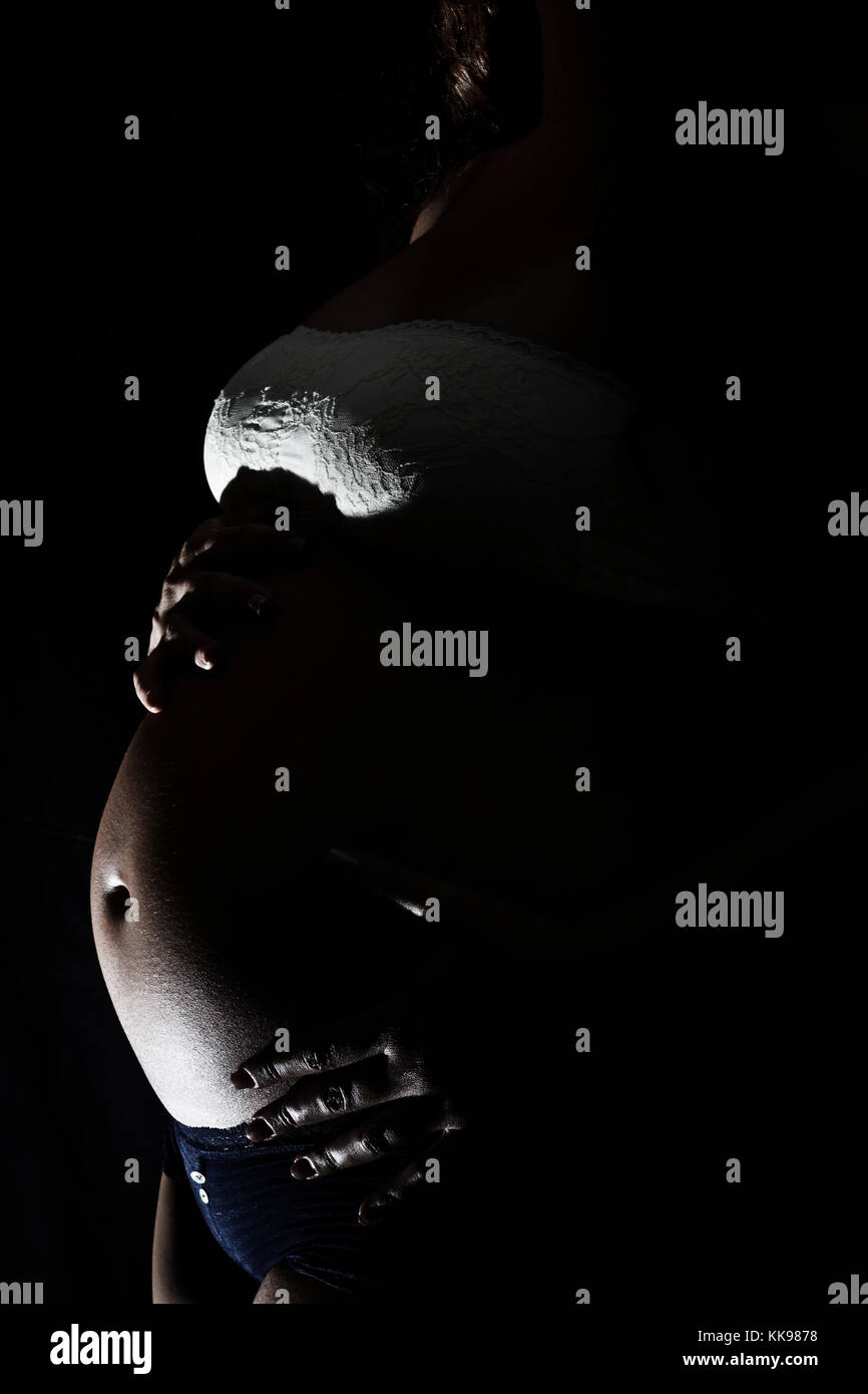 Creative dark picture with a pregnant woman. Low key technique Stock ...