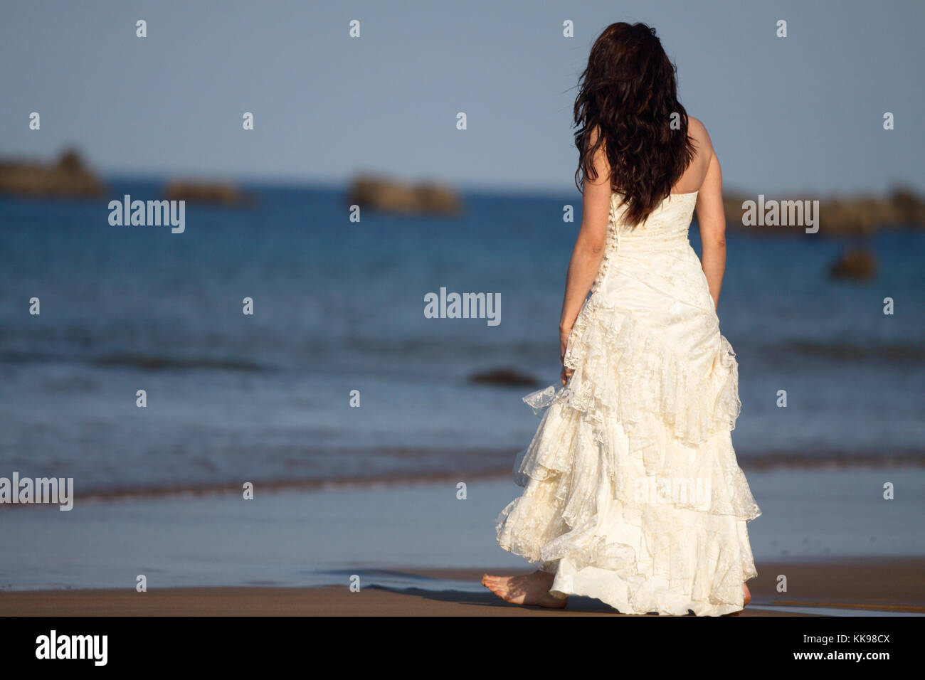 Bride walking in the beach Stock Photo - Alamy