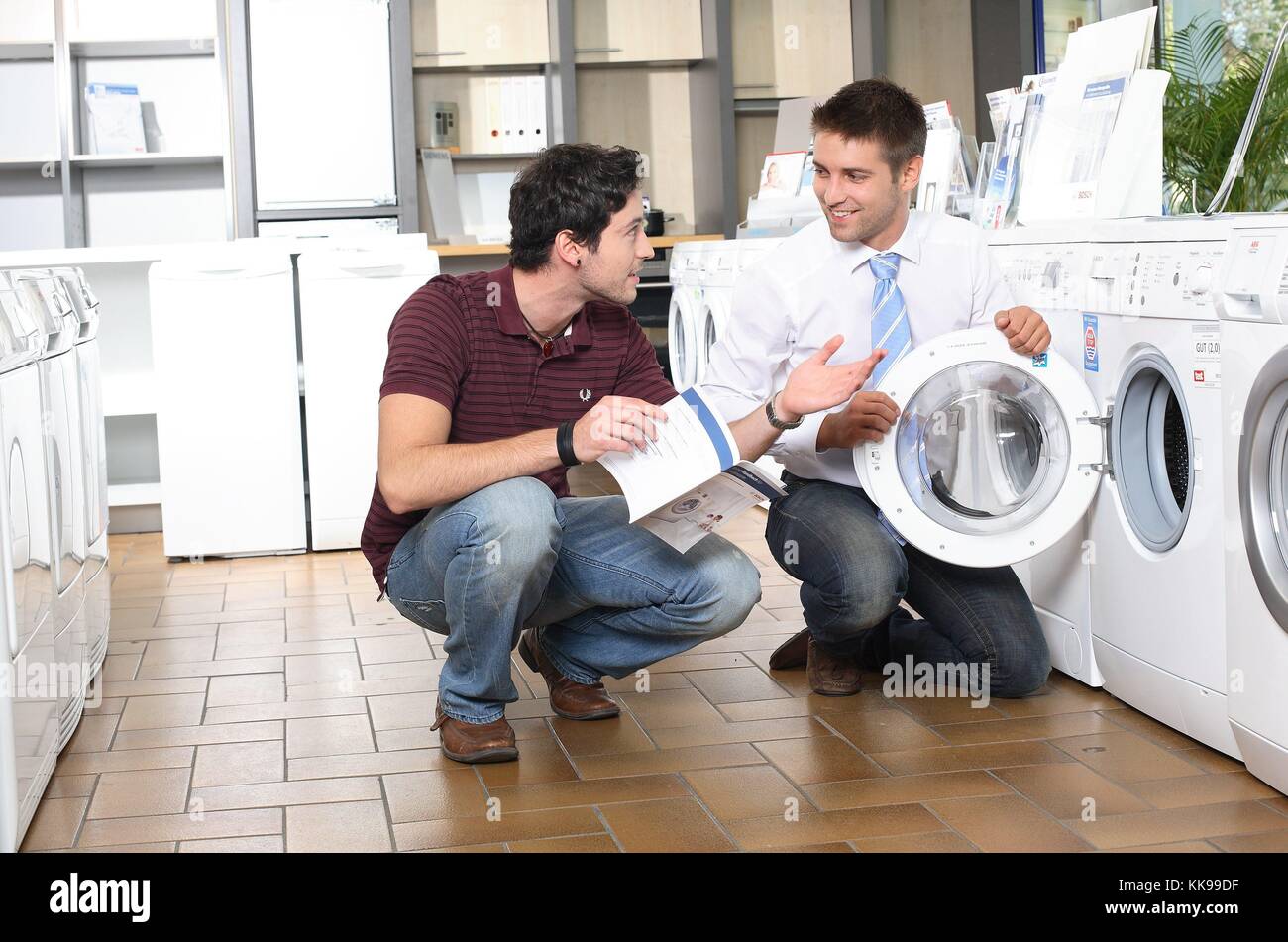 Woman closing washing machine hi-res stock photography and images - Alamy