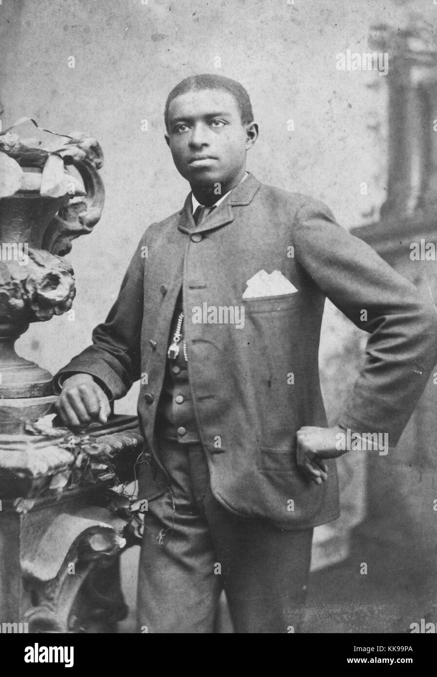 Sepia studio portrait of a young African-American man, three quarter ...
