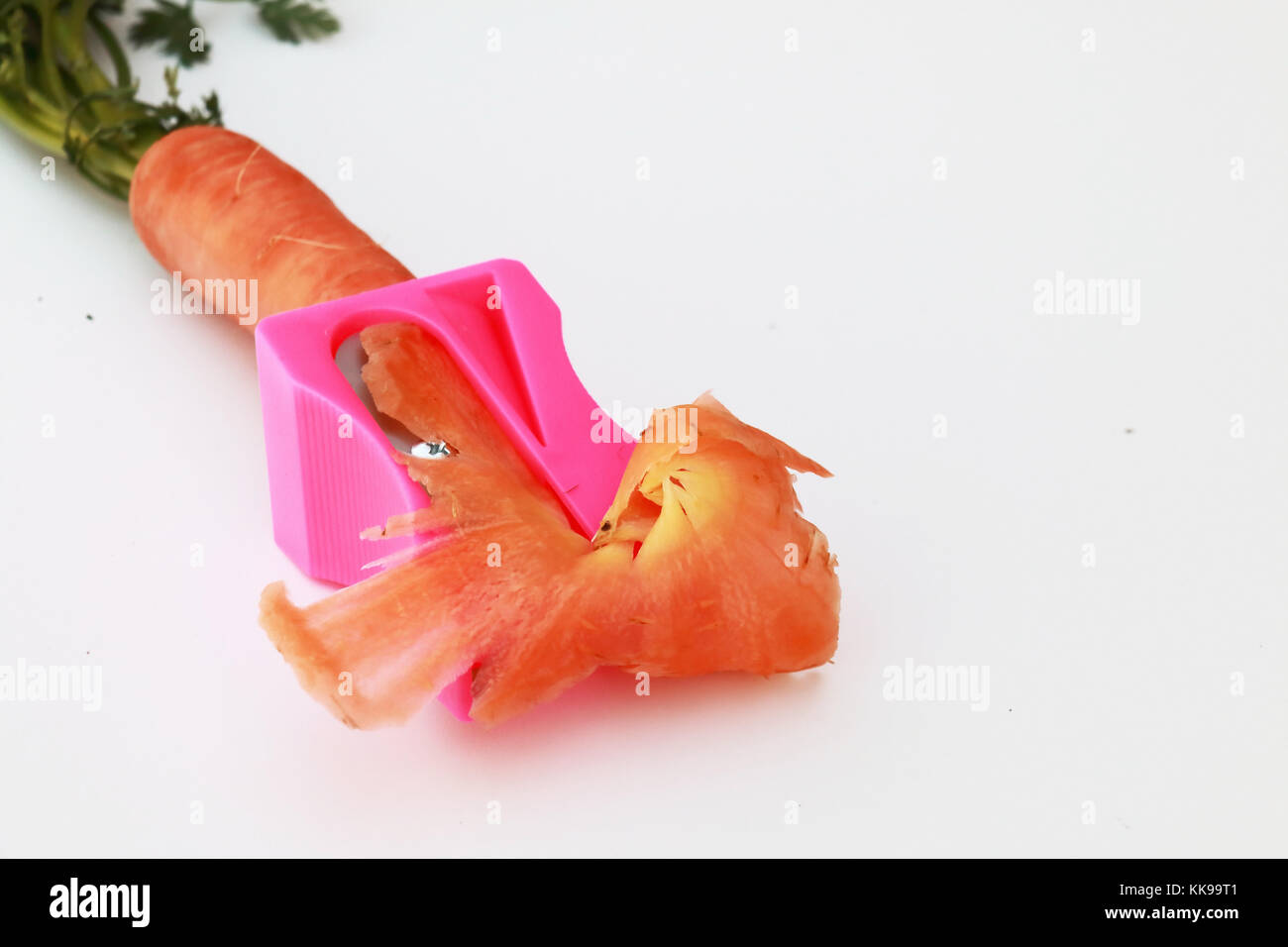 Sharpening tip to a carrot with a pencil sharpener Stock Photo - Alamy