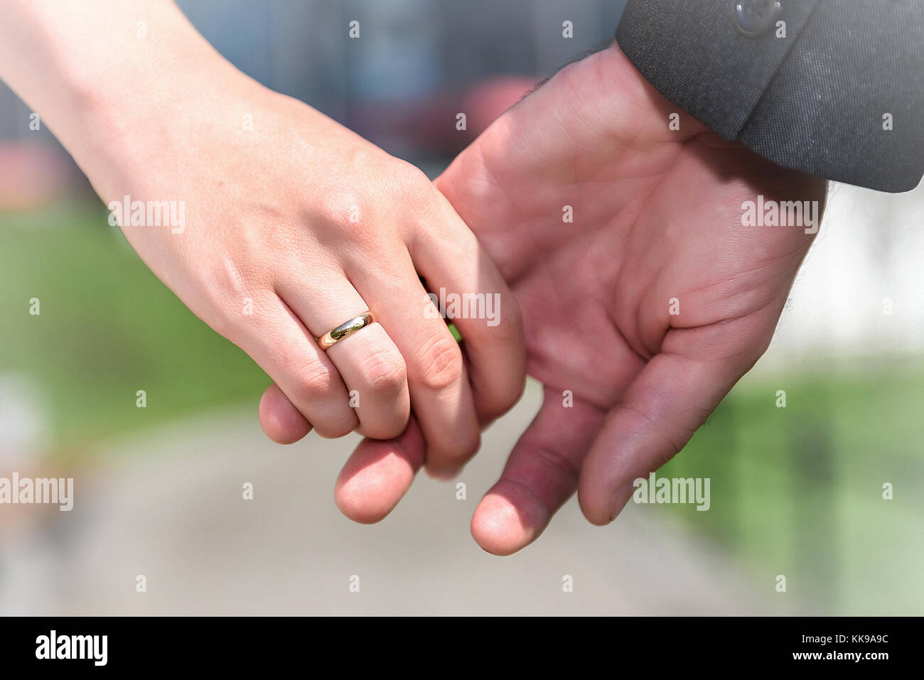 Closeup of bride and groom showing wedding rings touching hands Stock ...