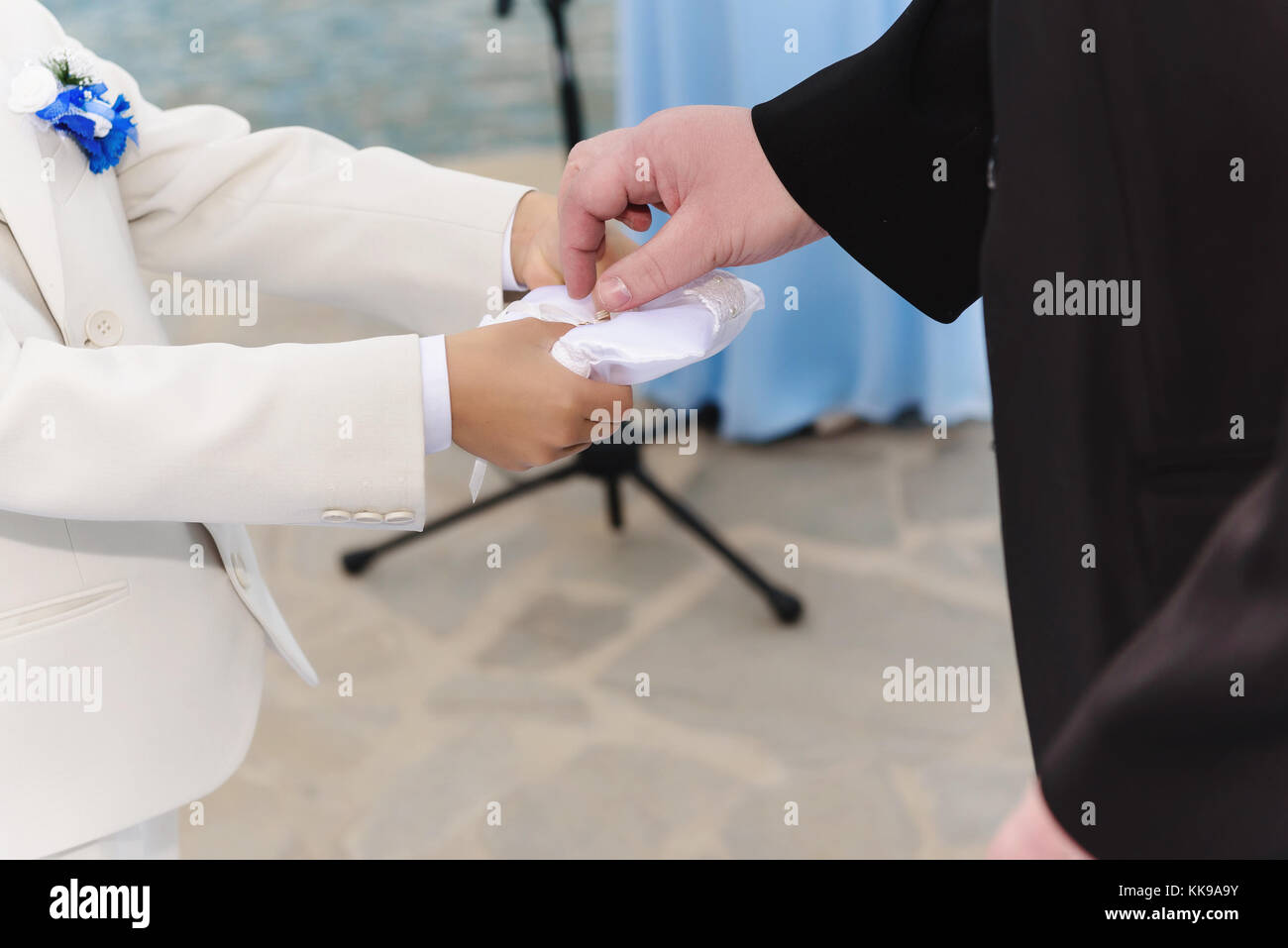 Little boy gives wedding rings to groom in bright blue suit Stock Photo ...
