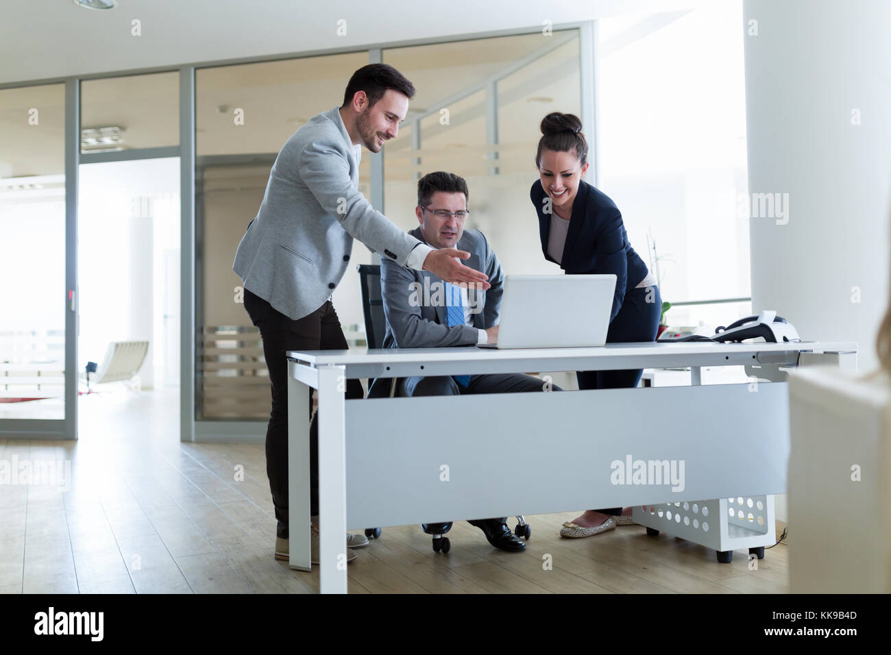 Picture of sales agents working together in office Stock Photo - Alamy