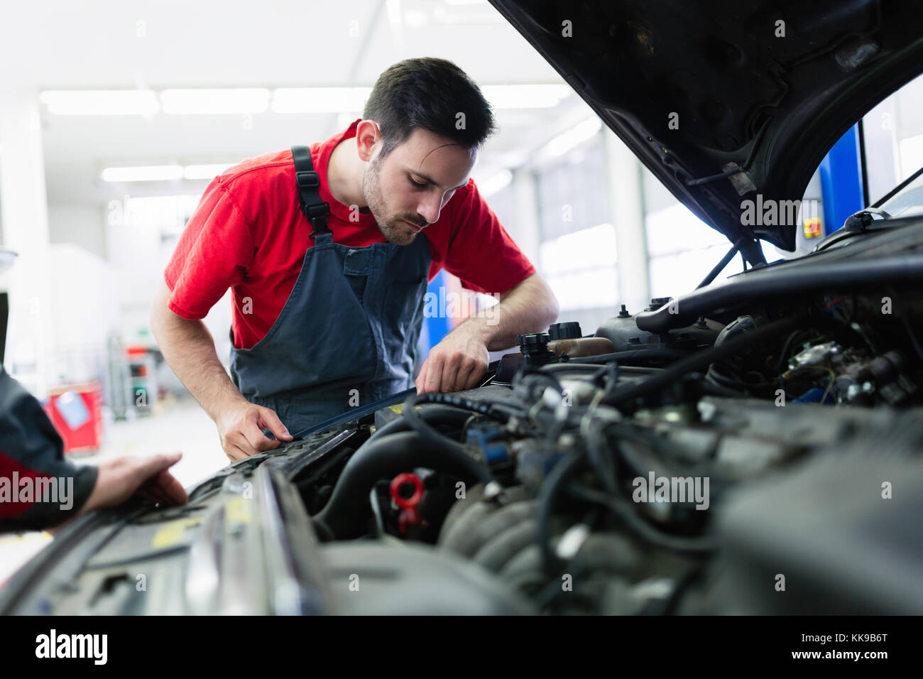 Car mechanic working at automotive service center Stock Photo - Alamy