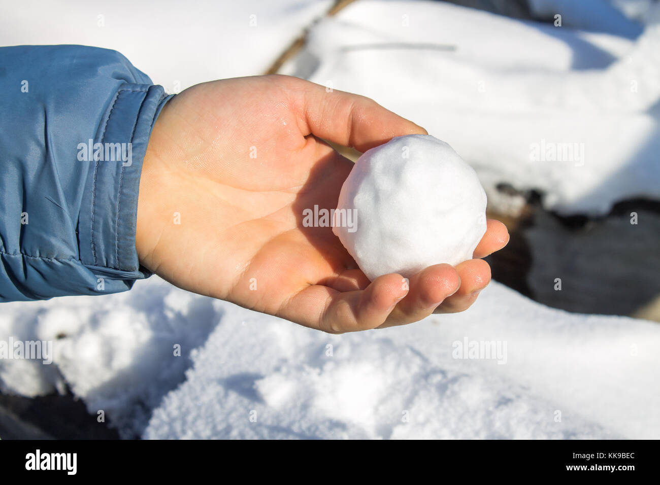Male hands sculpting from the snow small snowballs that would make a ...