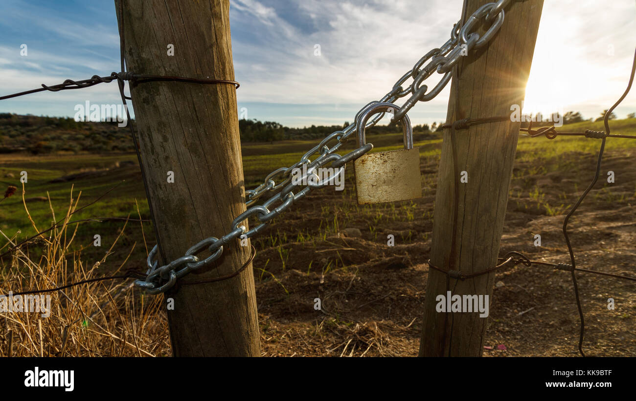 Padlock and chained gate into a newly planted field in Castelo Branco ...