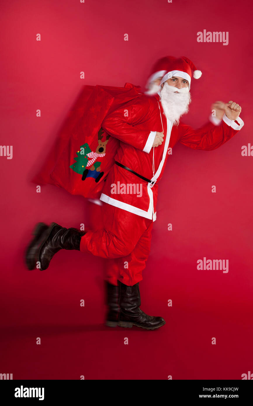 Santa Claus is in a hurry to deliver gifts Stock Photo - Alamy