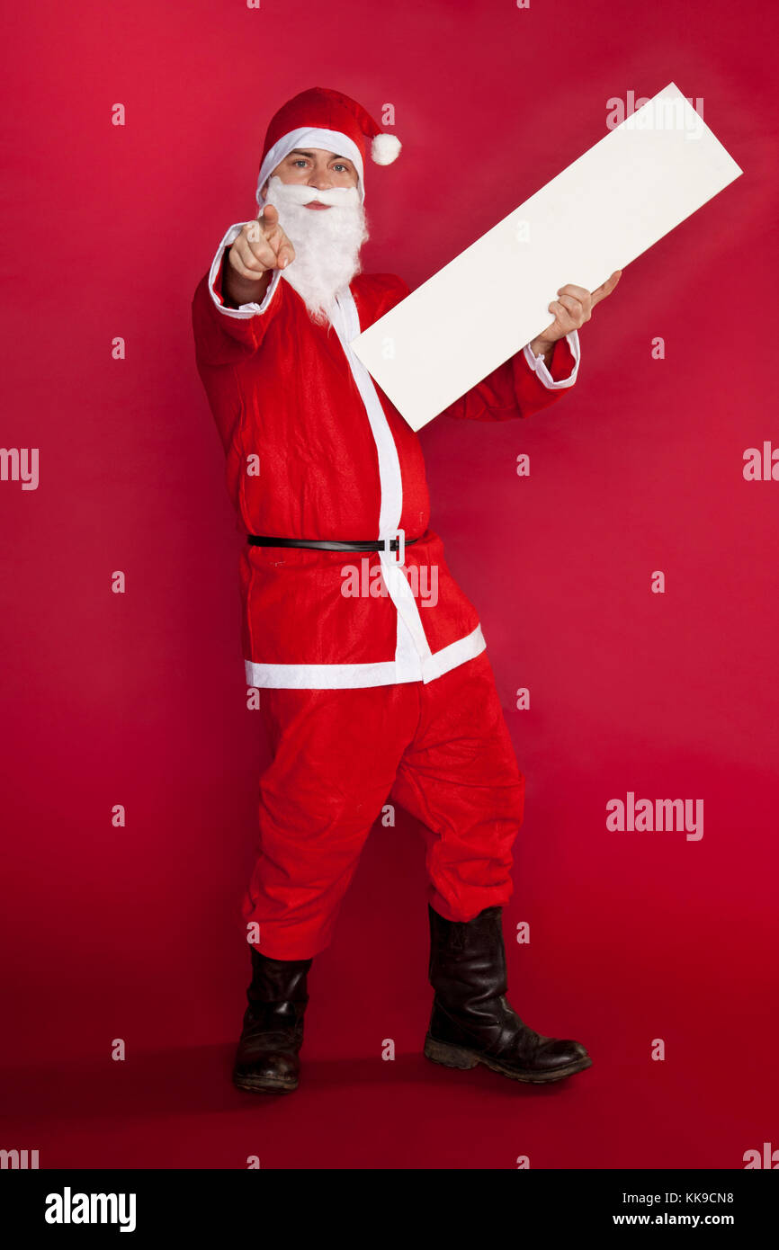 happy santa clause keeps a place for advertising, pointing at you Stock ...