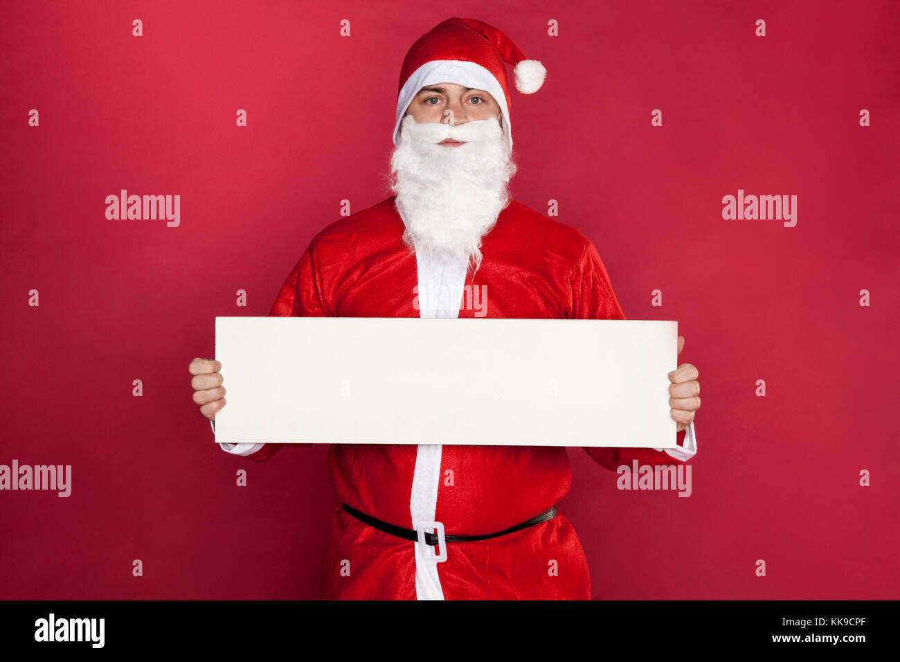 Disappointed Santa Claus keeps advertising in front of him Stock Photo ...