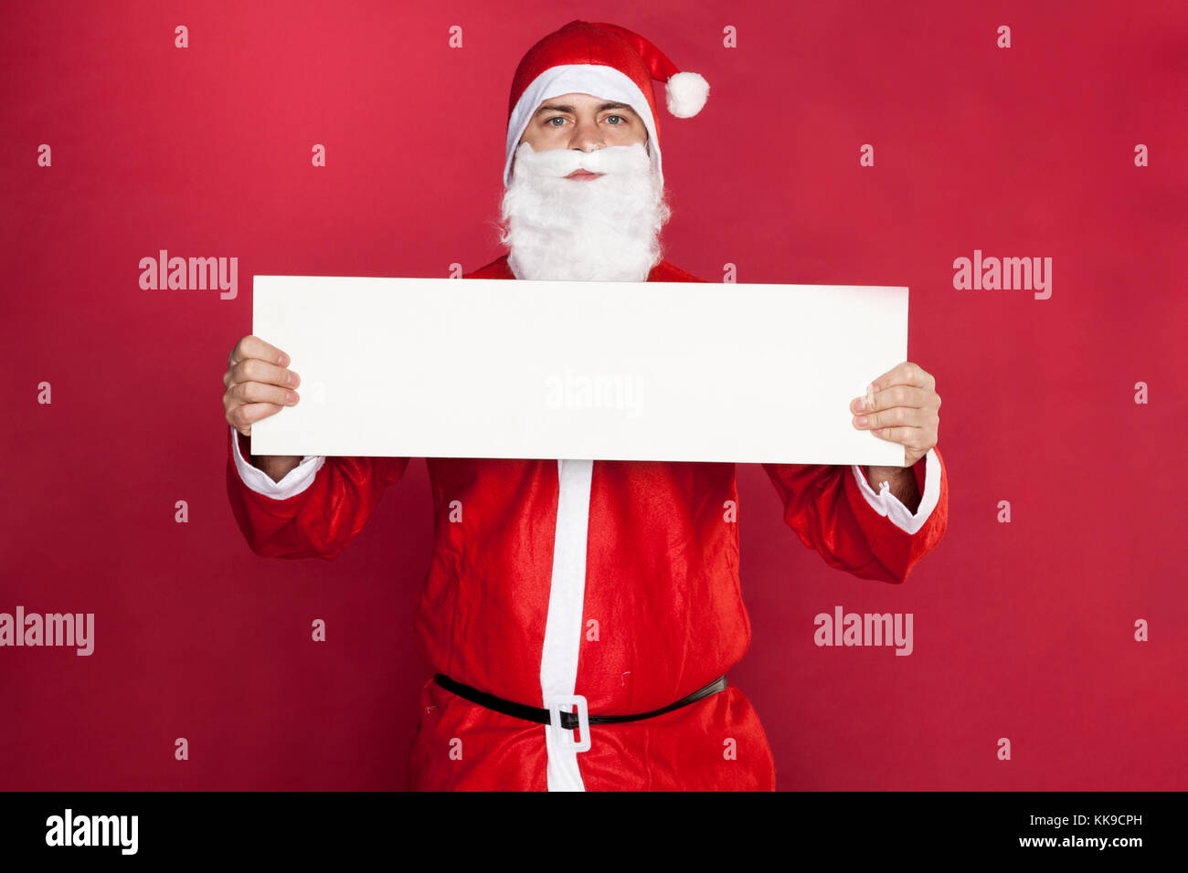 Santa Claus is holding an advertisement in front of him Stock Photo - Alamy