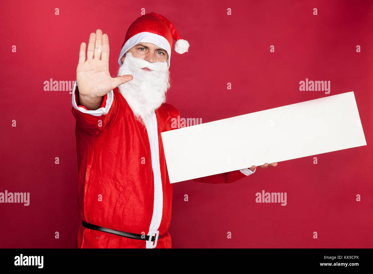 Santa Claus performs a stop gesture, advertising in his hand Stock ...