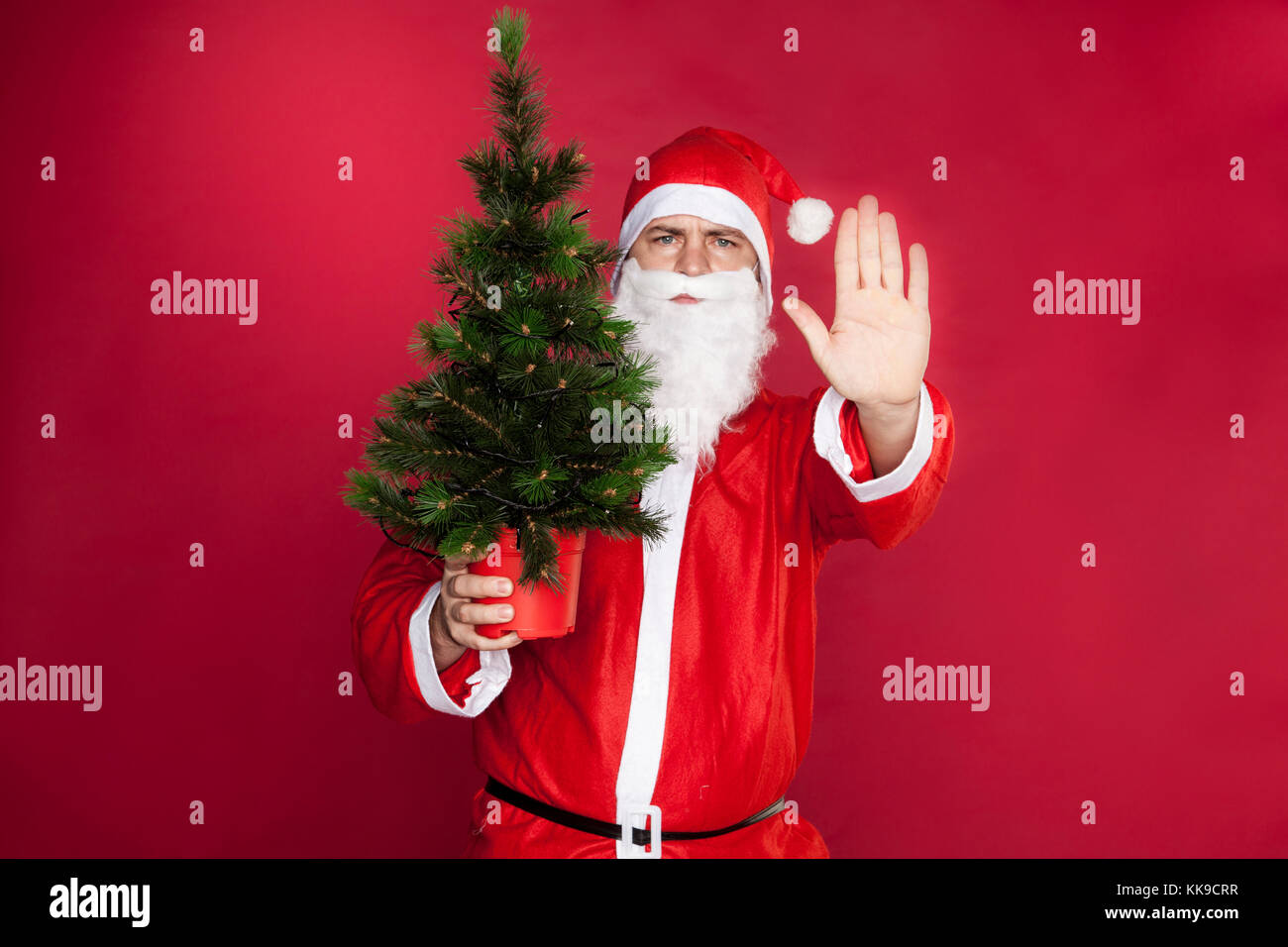 Santa makes a stop sign with his hand Stock Photo - Alamy