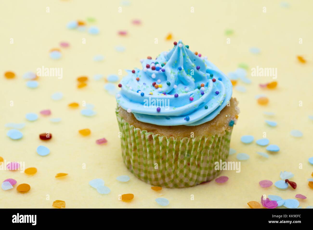 cupcake with blue whipped cream and sprinkles Stock Photo - Alamy
