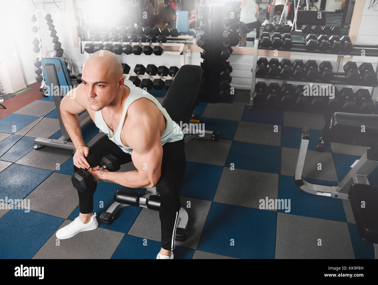 Strong athletic men pumping up muscles and train in gym workout ...