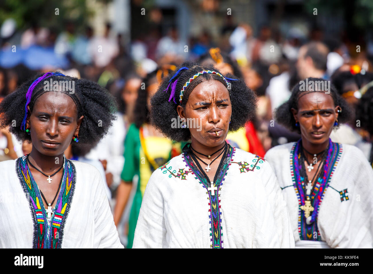 Three adult women enter the main stage area at the Ashenda Festival ...