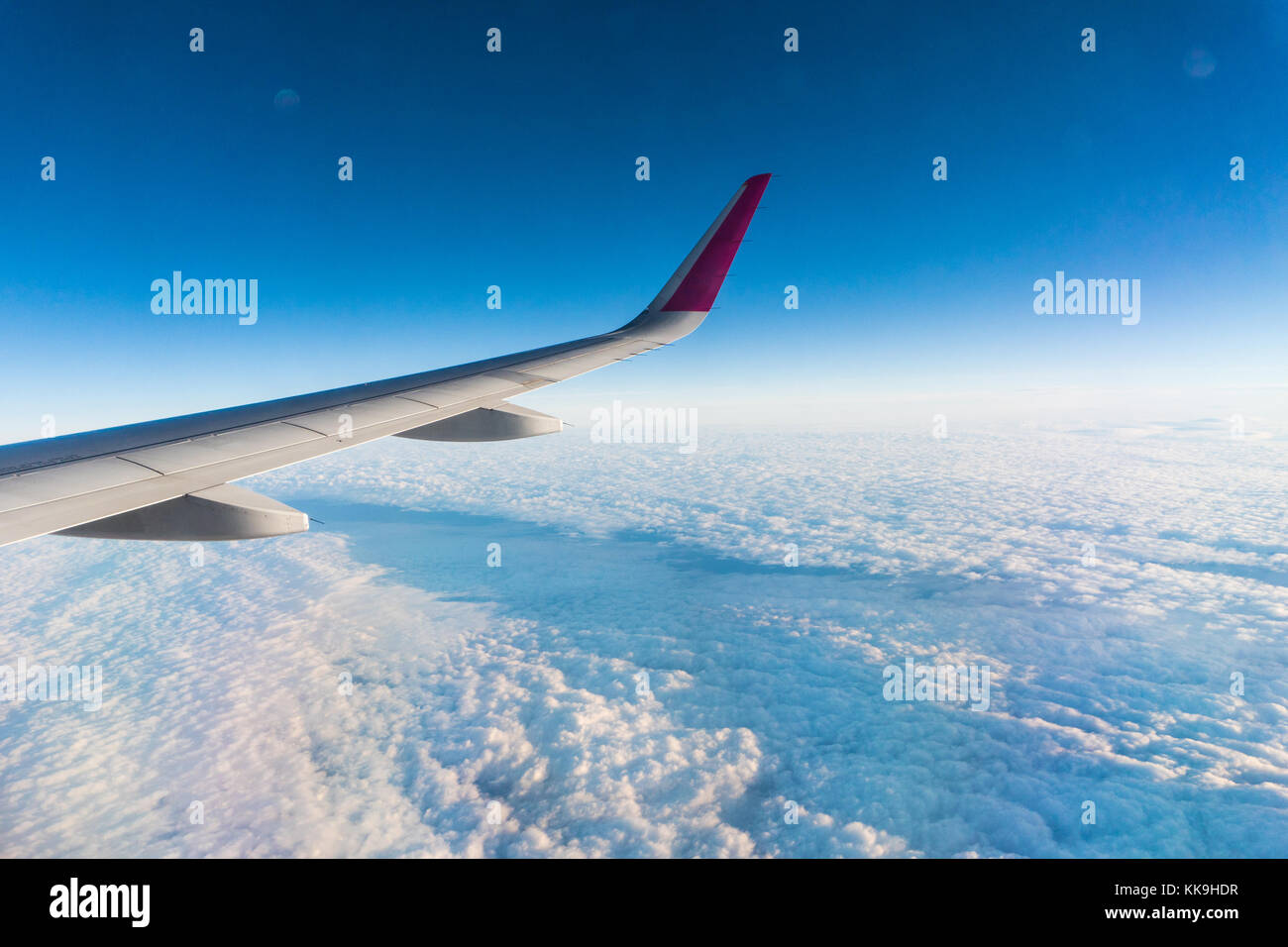 Wing of the plane on sky background. plane wing with cloud patterns ...