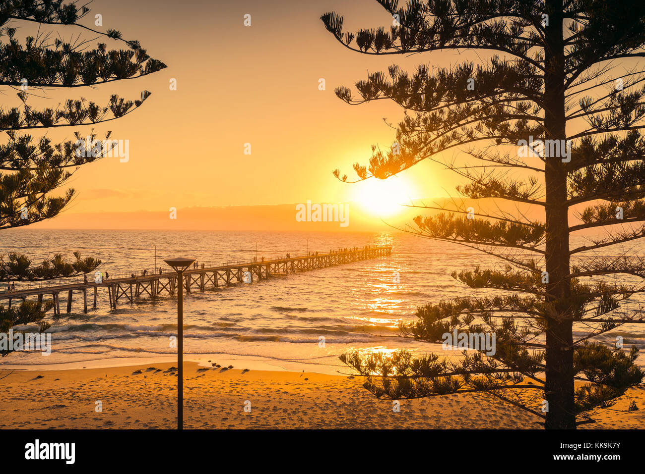Port Noarlunga beach jetty with people at sunset, South Australia Stock ...
