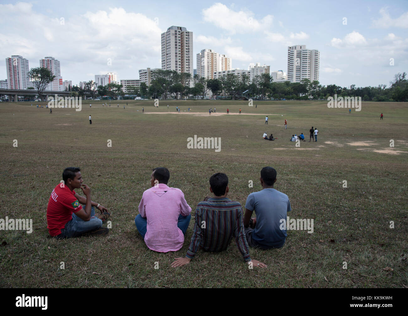 Migrant construction workers from Bangladesh watching cricket in ...