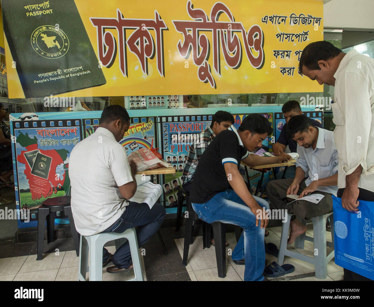 Migrant construction workers from Bangladesh filling work permit forms ...
