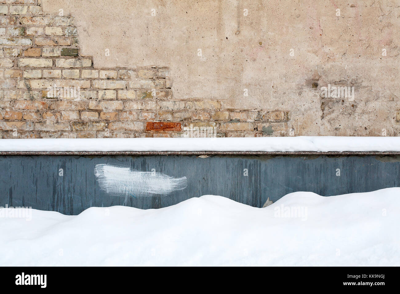 Modern wall of stone bricks and a ground covered with snow Stock Photo ...