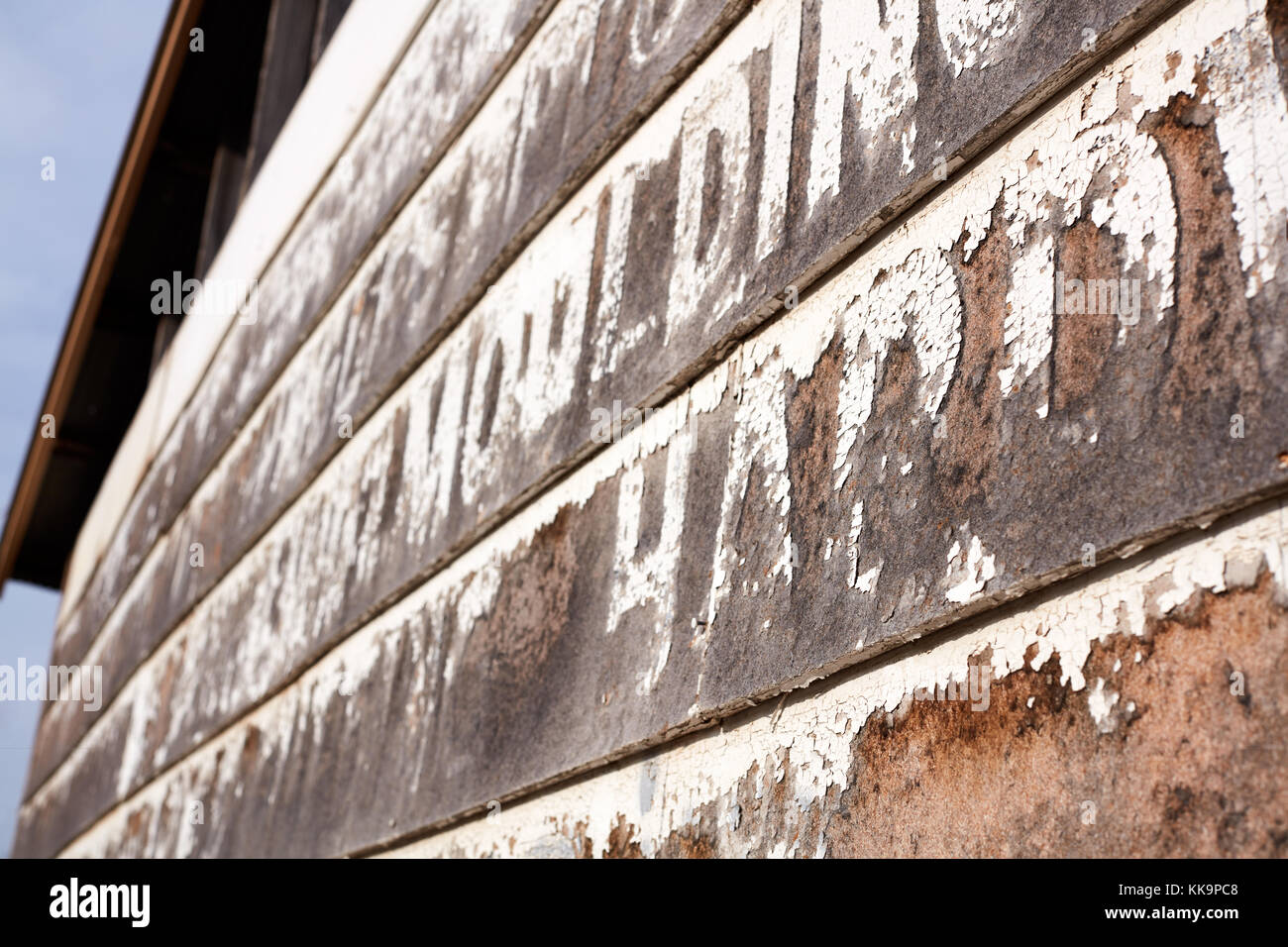 Old rustic wooden clad building with the remnants of white lettering in ...