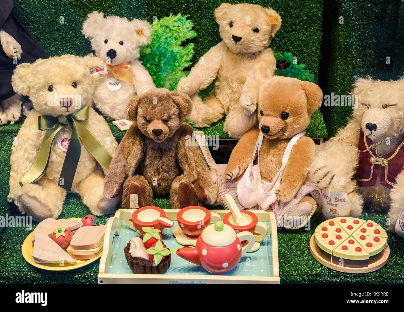 A group of teddy bears in a toy shop window displayed having a picnic ...