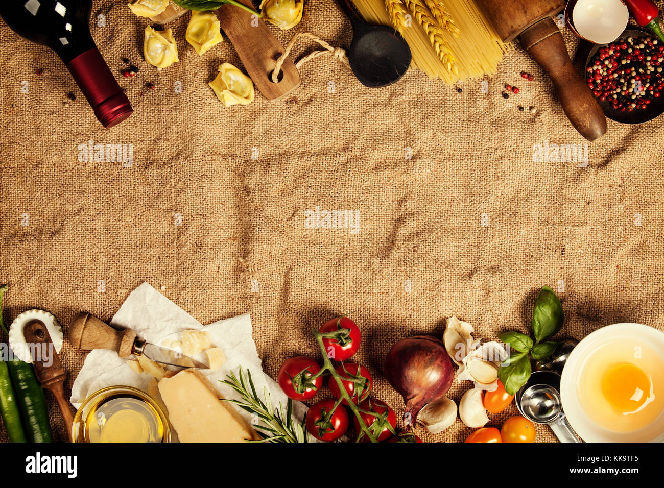 Italian food background with vine tomatoes, basil, spaghetti, spinach ...