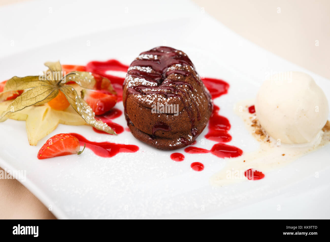 Chocolate fondant with vanilla ice cream and raspberry sauce Stock ...