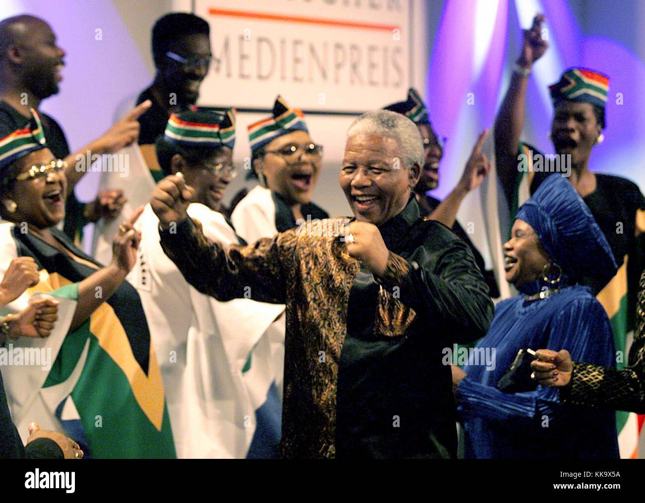 South African president Nelson Mandela, in the middle, dances with his ...
