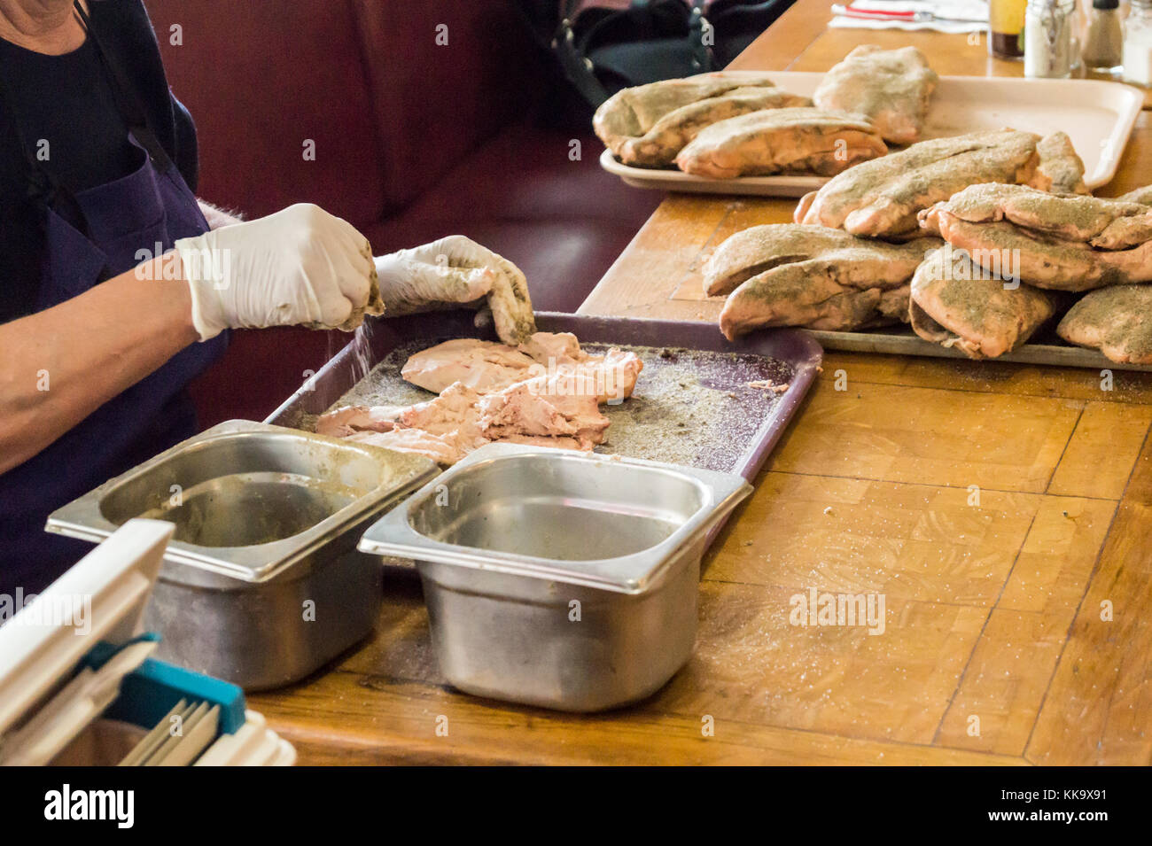 A woman preparing foie gras entier, whole goose liver, Le Louchebem ...