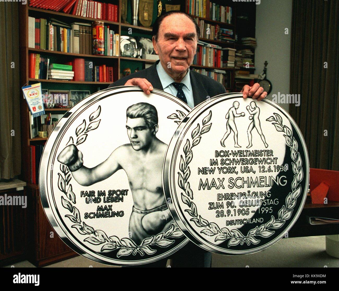 Box idol Max Schmeling in his office presents models of medals of ...