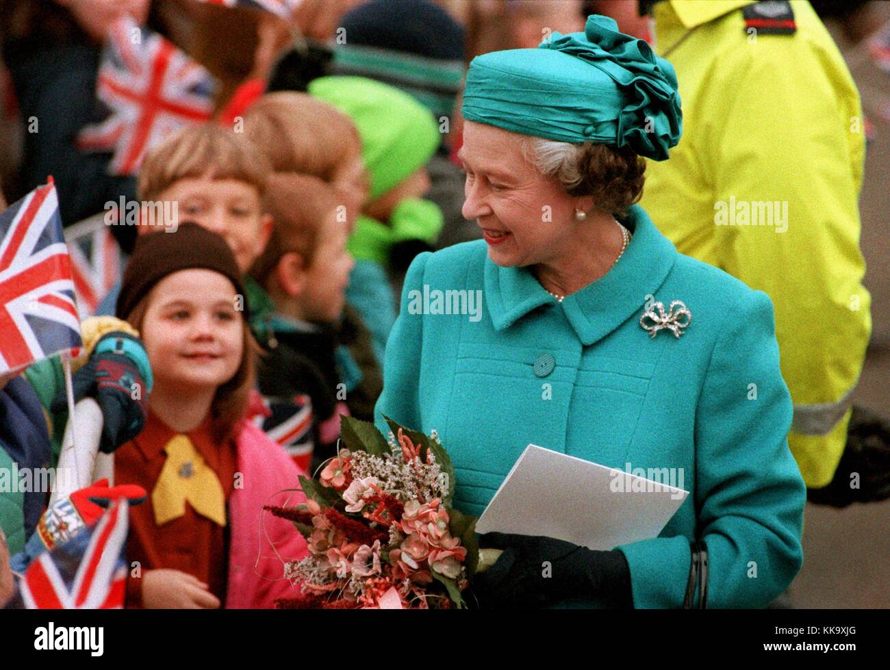 Queen Elizabeth II rejoices at the warm welcome by children waving with ...