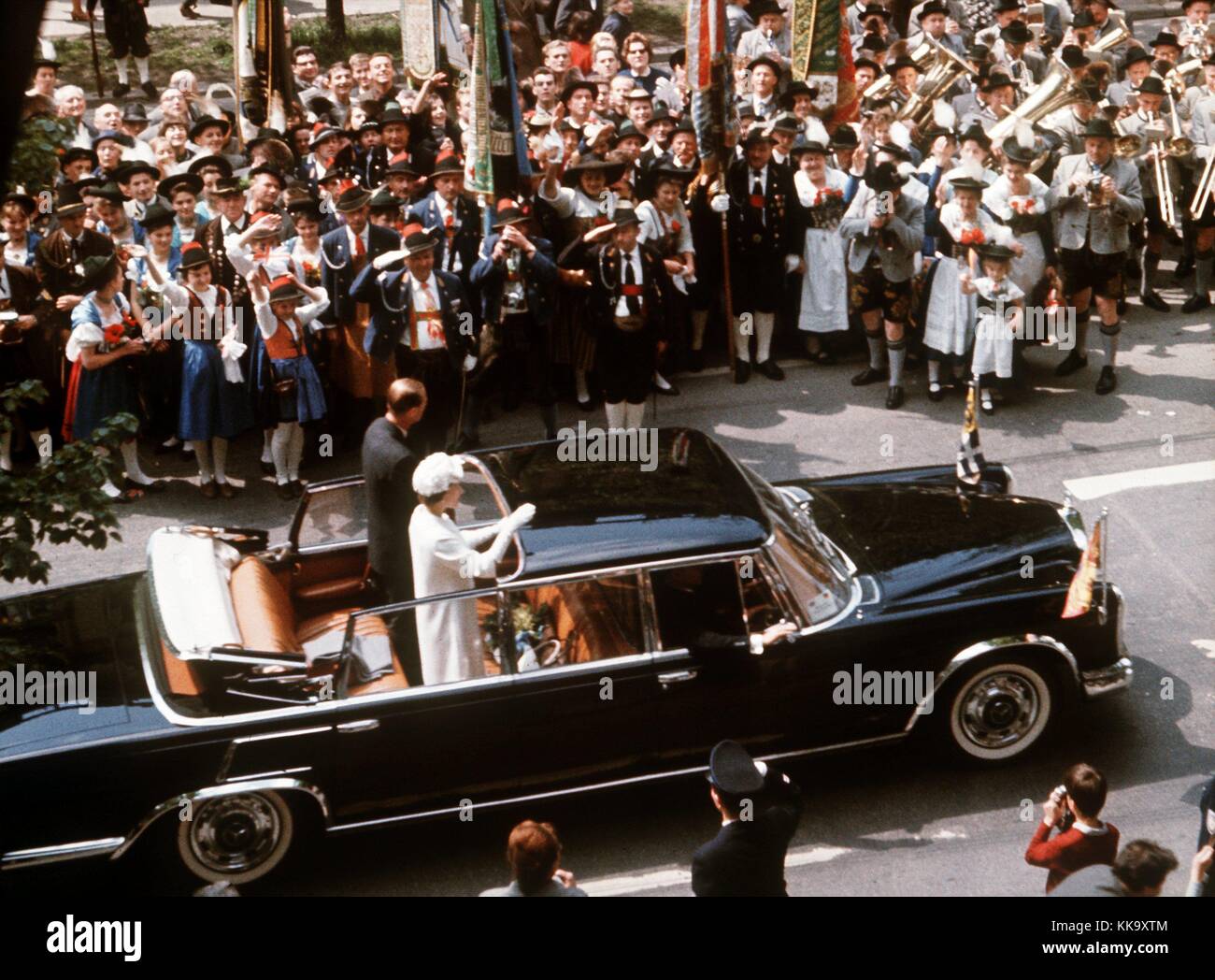 Queen Elizabeth II and her husband Prince Philip are standing in an ...
