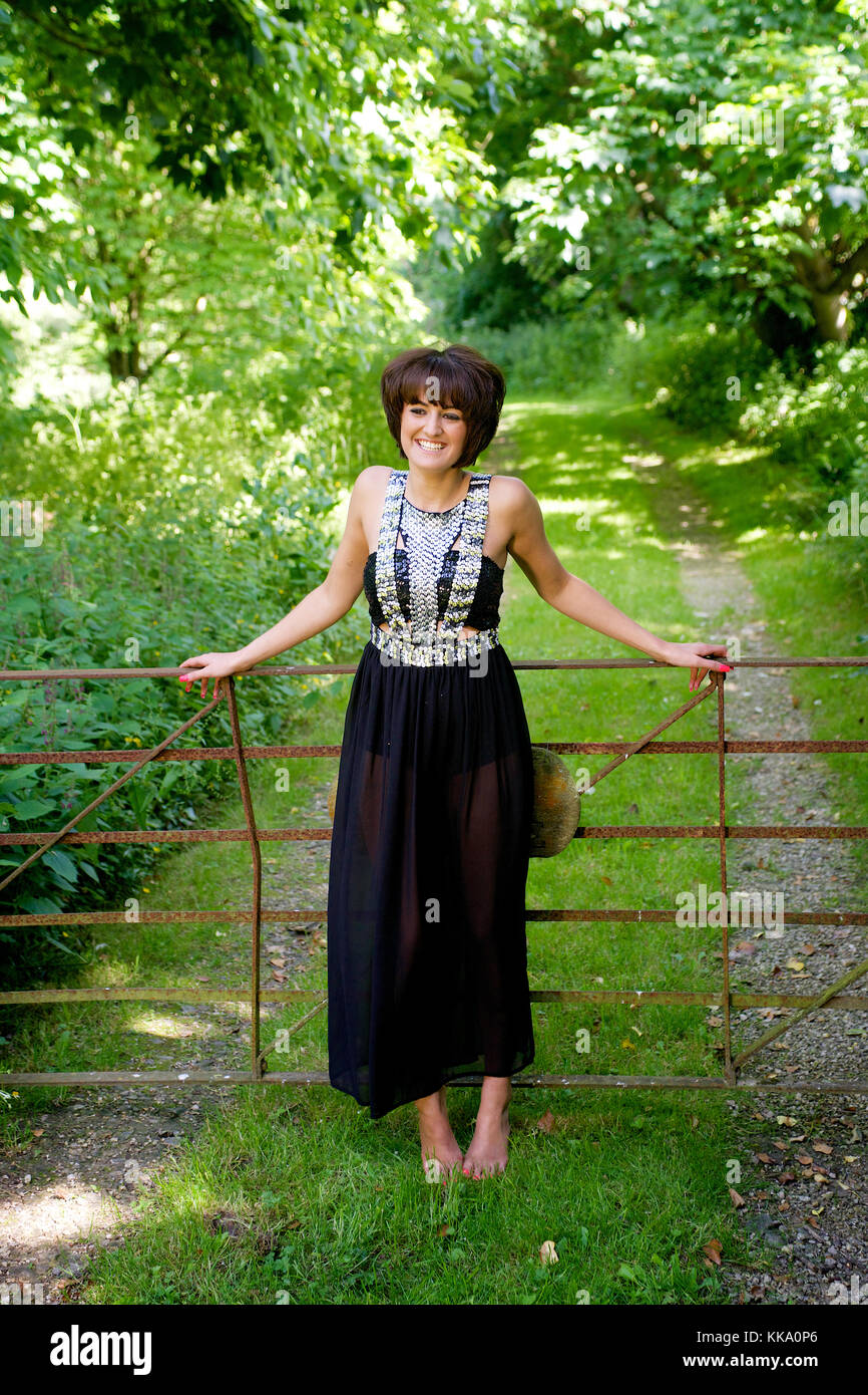 Pretty girl in the countryside wearing a black outfit Stock Photo - Alamy
