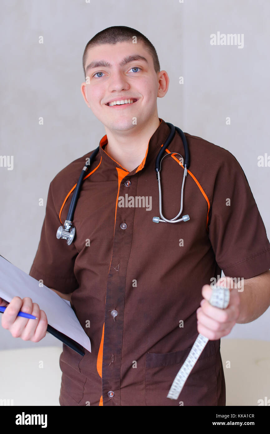 Professional male therapist looks at camera with smile and stand Stock ...