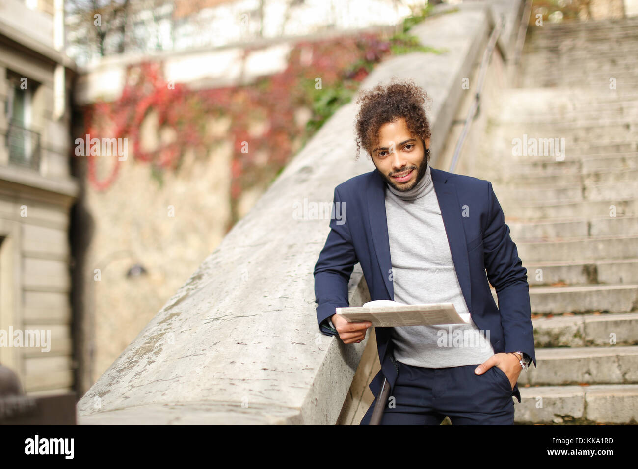 Upset guy reading newspaper outdoor Stock Photo - Alamy