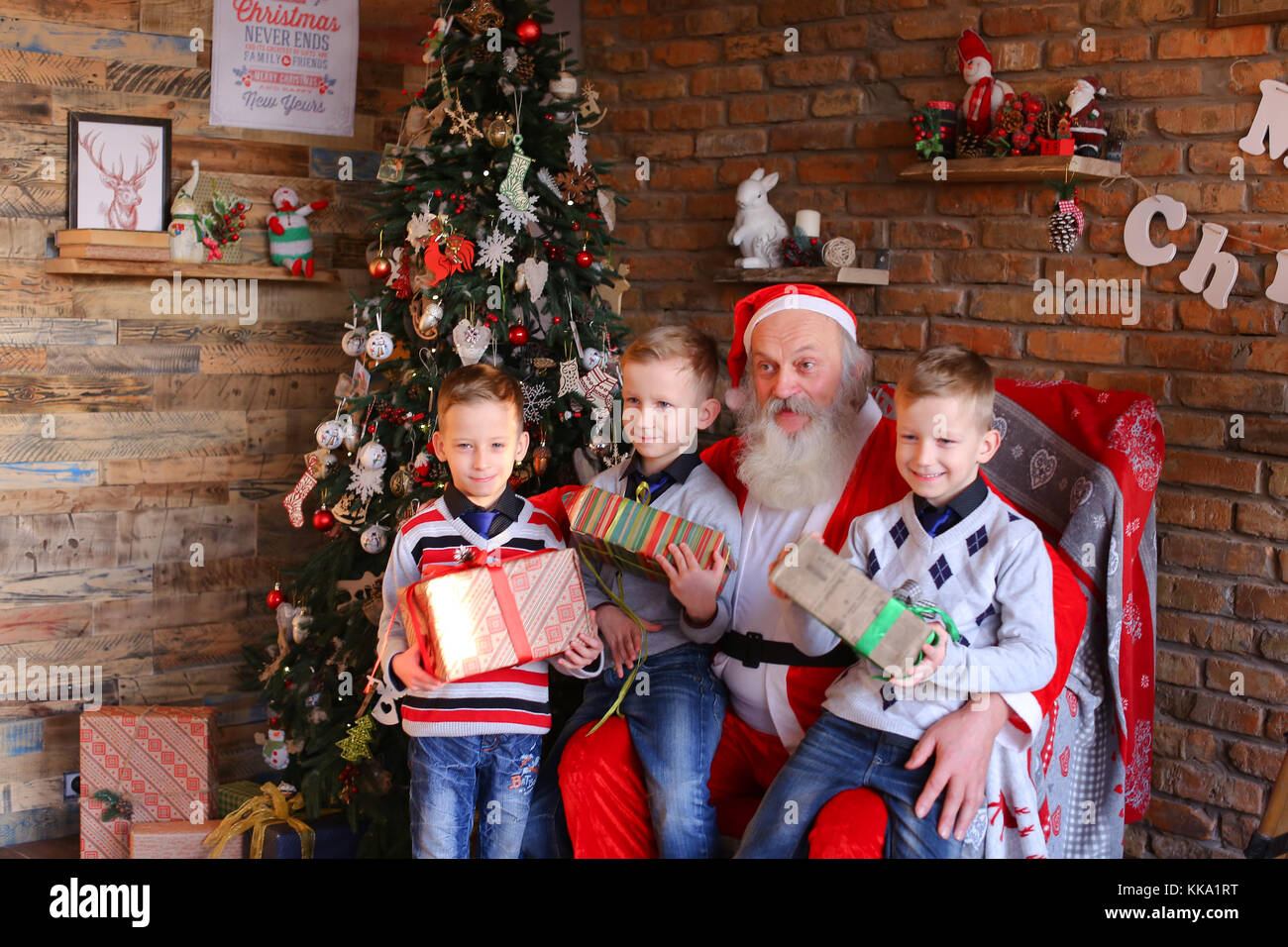 Native brothers boys sing Christmas carols to Santa Claus in roo Stock ...