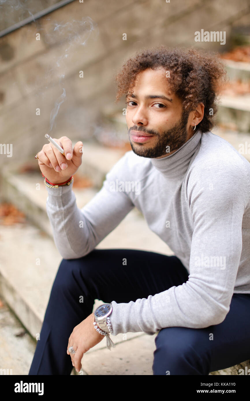 Close up face male person smoking on steps Stock Photo - Alamy