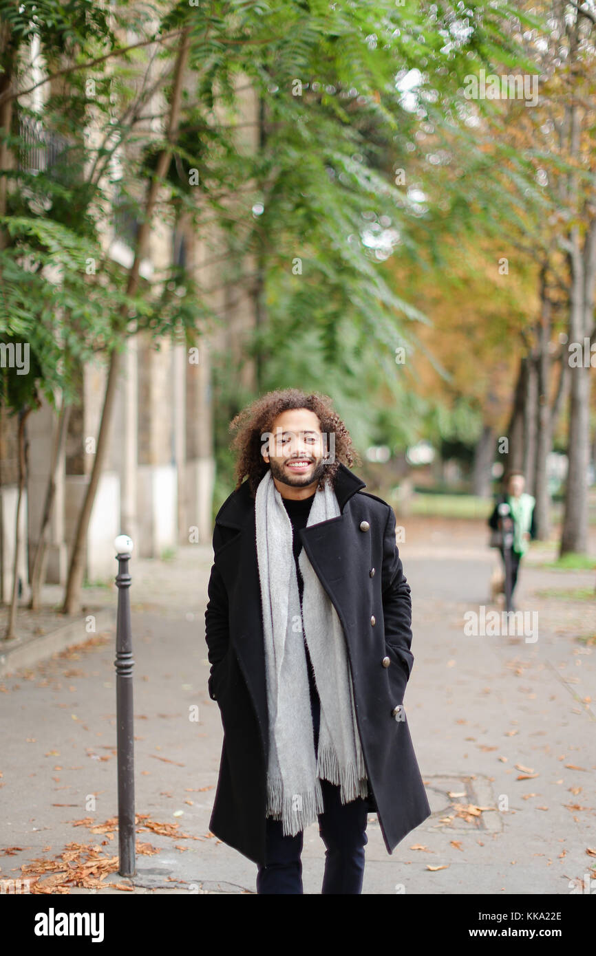 Jocund mulatto guy shaking head with fleecy hair and laughing Stock ...