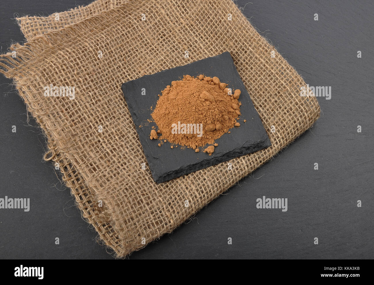 Carob powder on jute and shale Stock Photo - Alamy