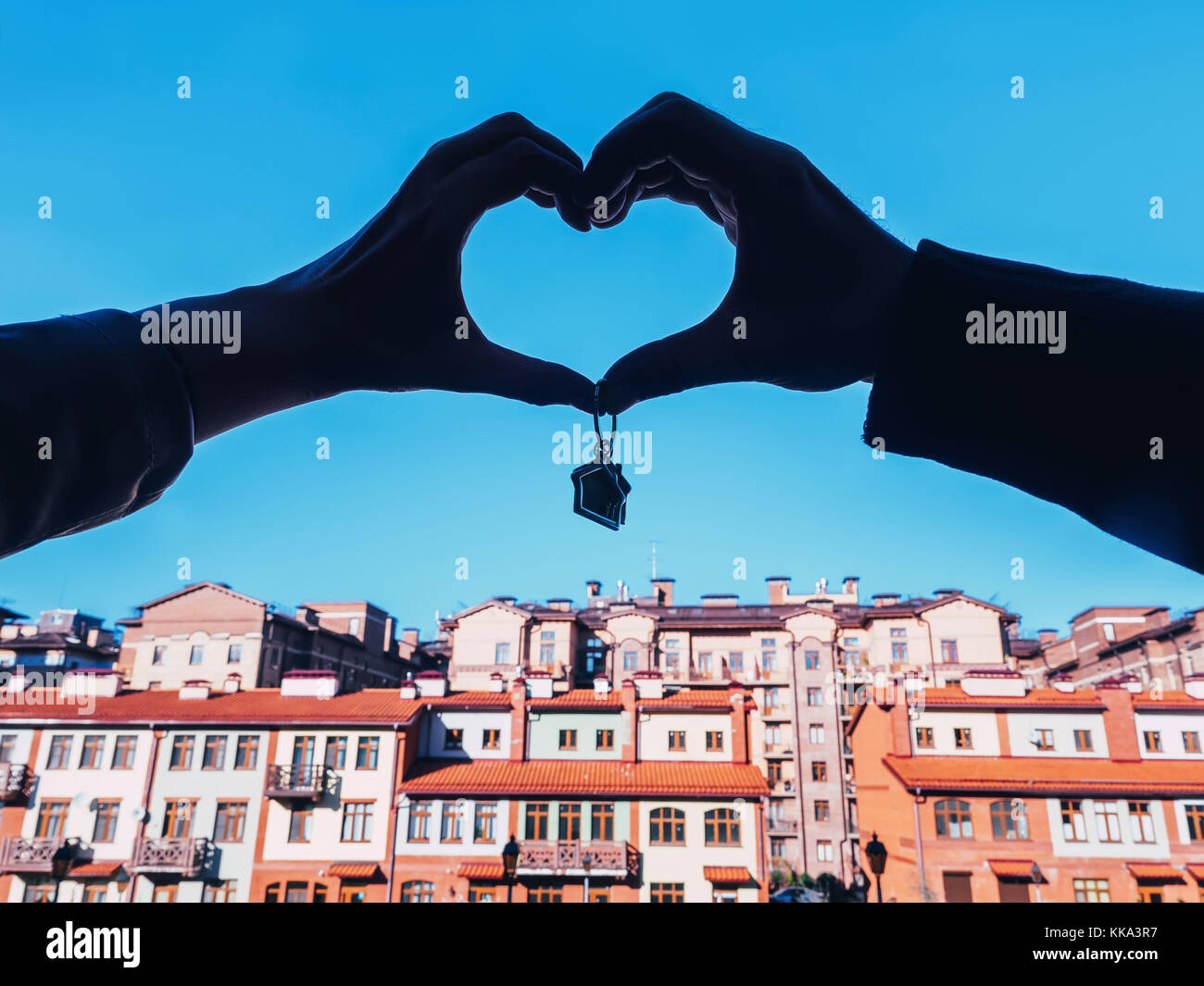Couple keeps keys new housing. hands silhouette holding house keys ...