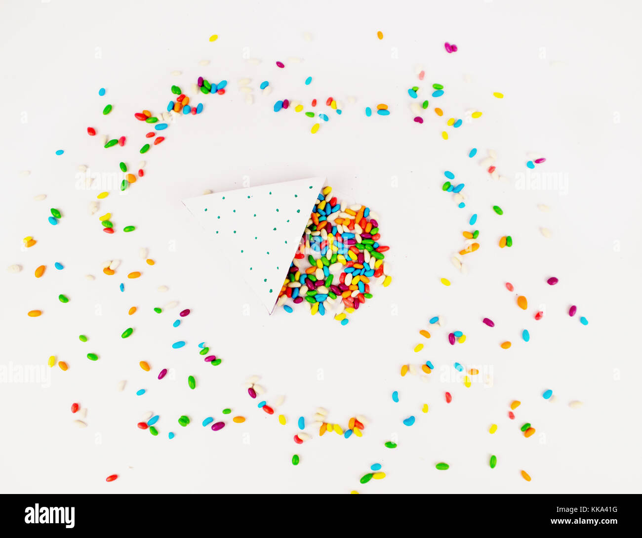 Christmas decoration triangle gift box with colorful candies surrounded ...