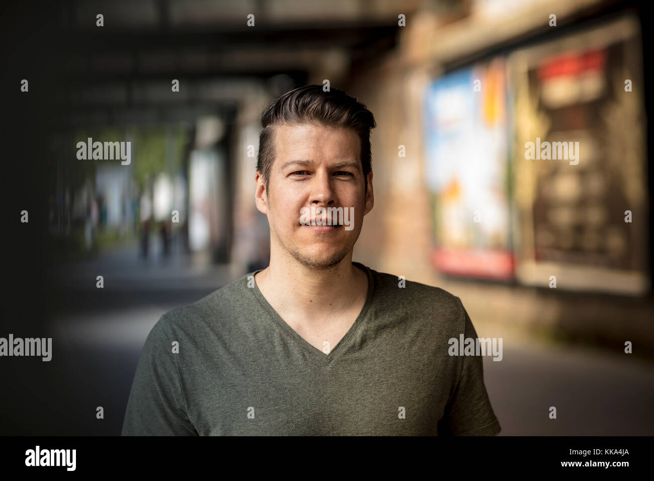A man wearing activewear standing under a city bridge Stock Photo - Alamy