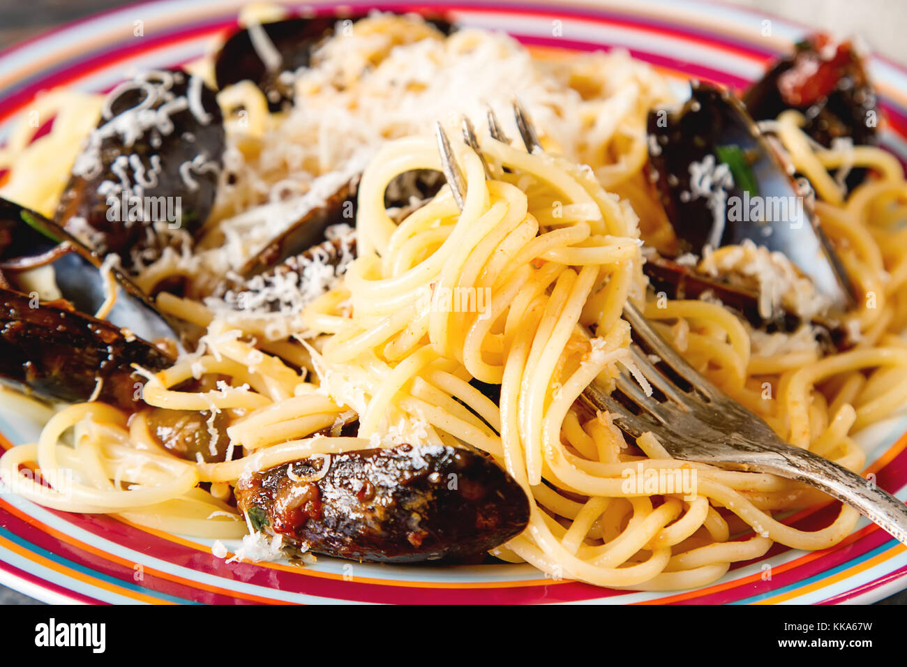 Spaghetti with mussels with herbs and tomato sauce in a plate. Seafood ...