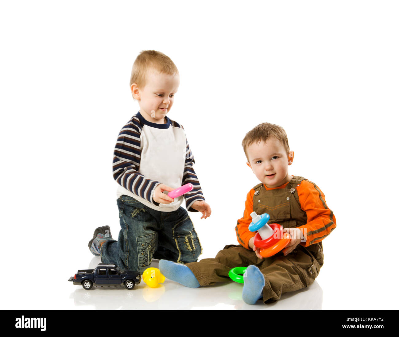Two boys playing with toys isolated on white Stock Photo - Alamy